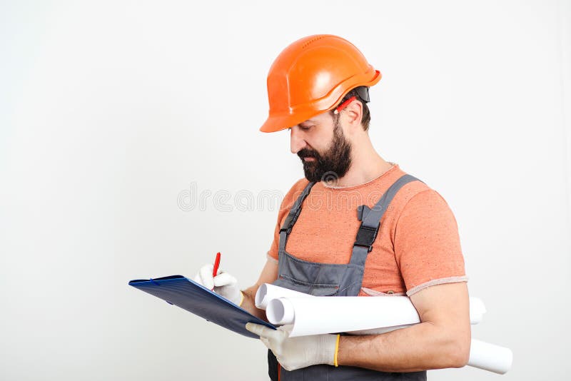Builder Taking Notes on Clipboard. Professional Builder with Safety ...