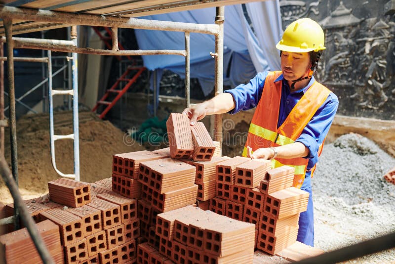 Builder Taking Orange Bricks Stock Photo - Image of manager, hardhat ...
