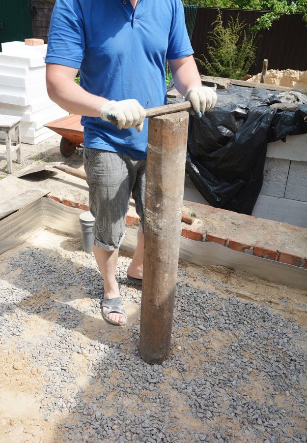 The Builder Tamping the Foundation in the House before Pouring Concrete ...