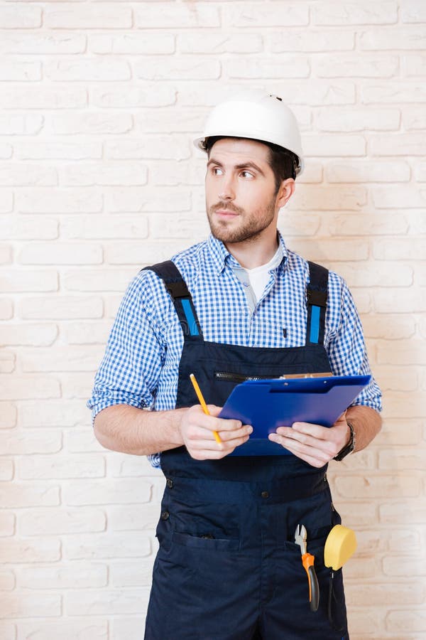 Builder Thinking about Something and Holding a Clipboard Stock Photo ...