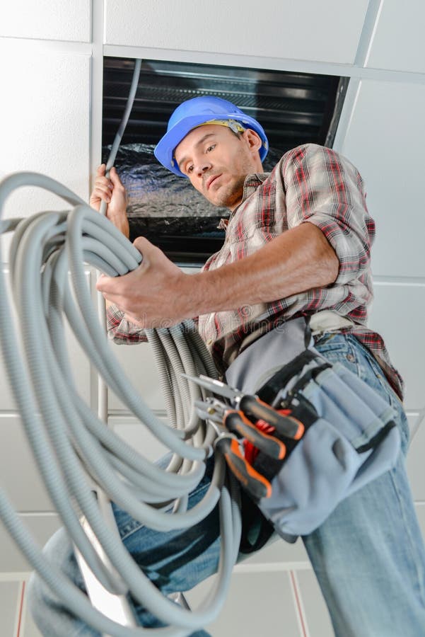 Builder Threading Cable into Roofspace Stock Image - Image of hardhat ...
