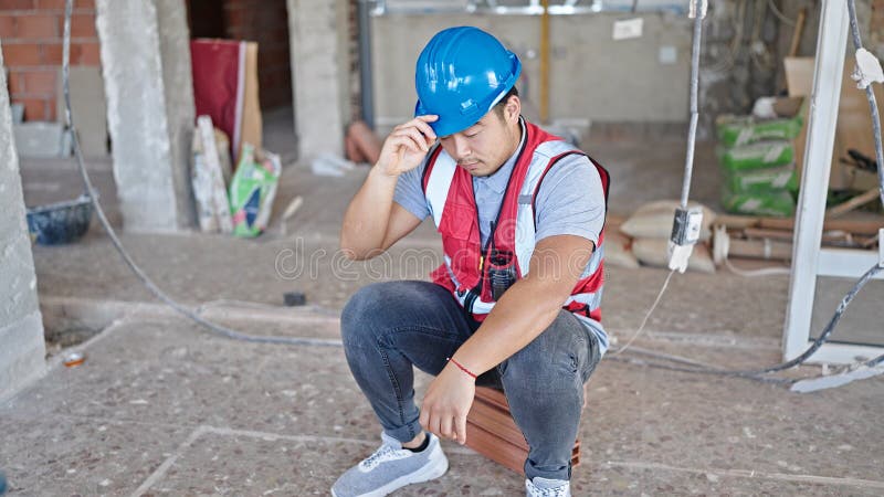 Builder Tired Sitting on Floor with Serious Expression at Construction ...