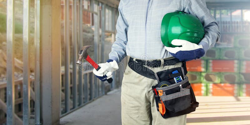 Builder with Tools Holds Hammer and Hard Hat in Hands Stock Photo ...