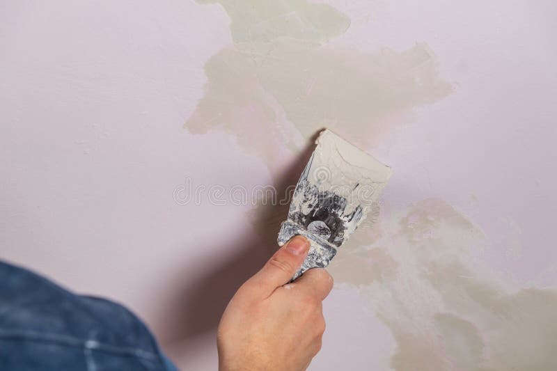 Builder with Trowel Plastering Wall or Ceiling. Close-up of the Master ...
