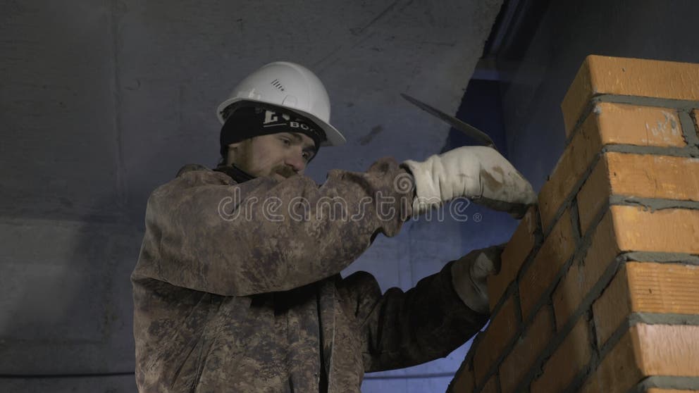Builder in Uniform Lays Brickwork. Clip. Man in Uniform Makes Brick ...