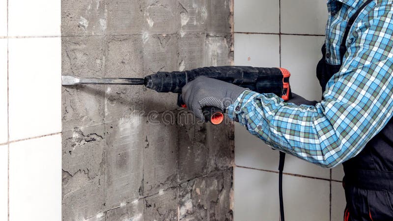 A Builder Uses a Perforator To Remove an Old Facing Tile during a ...