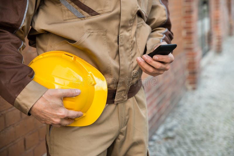 Builder using cellphone stock image. Image of person - 50583037