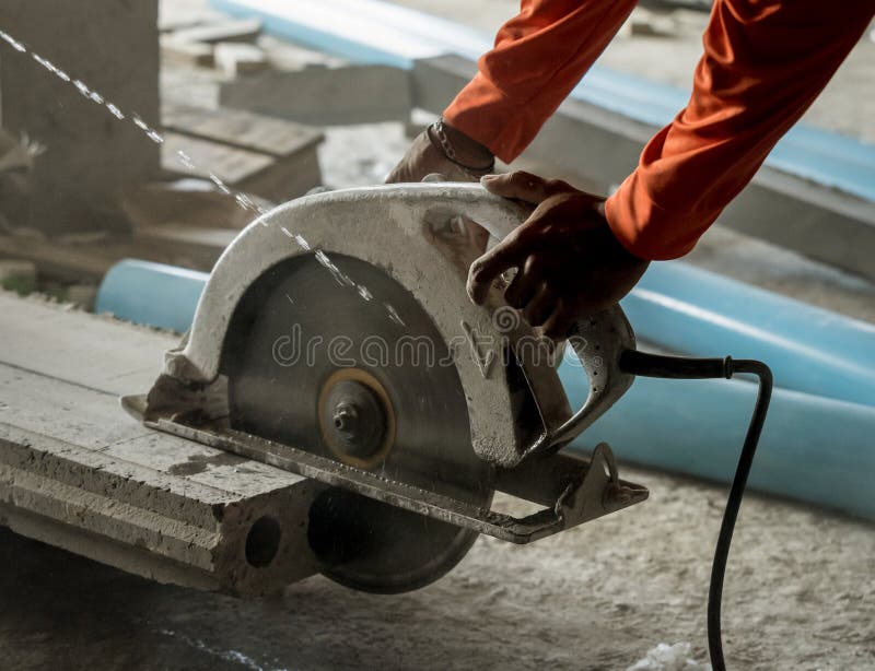 A Builder Using a Circular Saw To Cut a Large Concrete Piece Stock ...