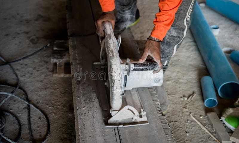 A Builder Using a Circular Saw To Cut a Large Concrete Piece Stock ...
