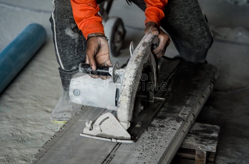 A Builder Using a Circular Saw To Cut a Large Concrete Piece Stock ...