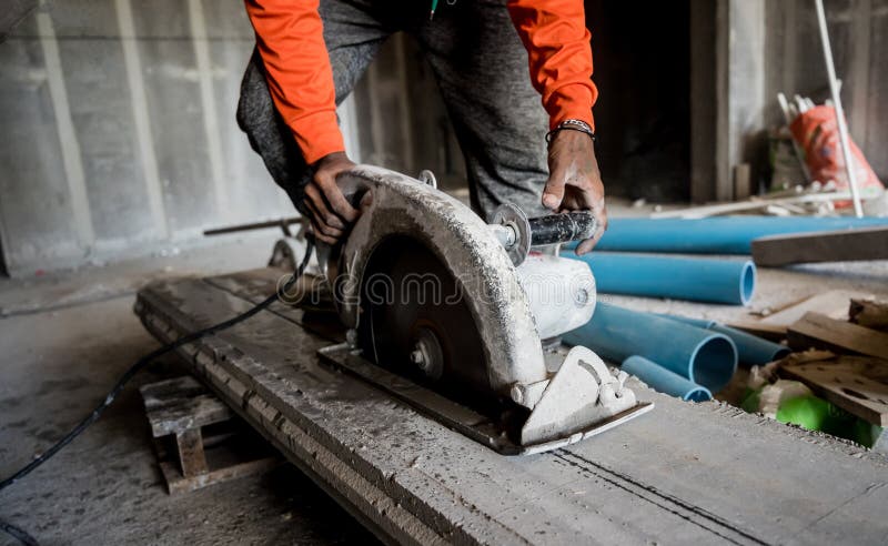 A Builder Using a Circular Saw To Cut a Large Concrete Piece Stock ...