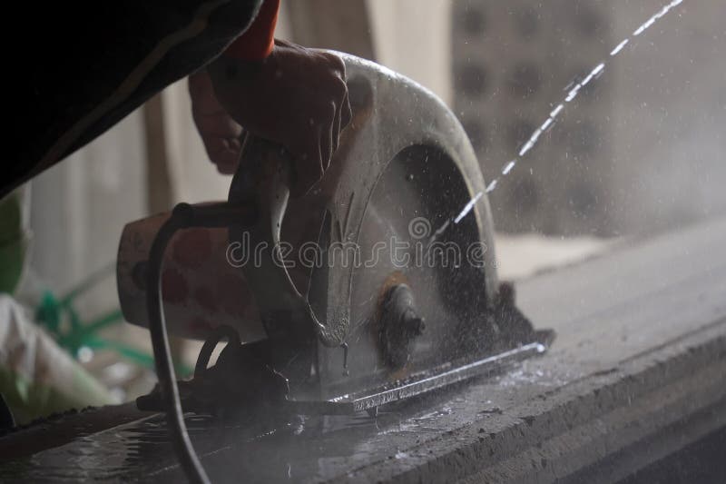 A Builder Using a Circular Saw To Cut a Large Concrete Piece Stock ...