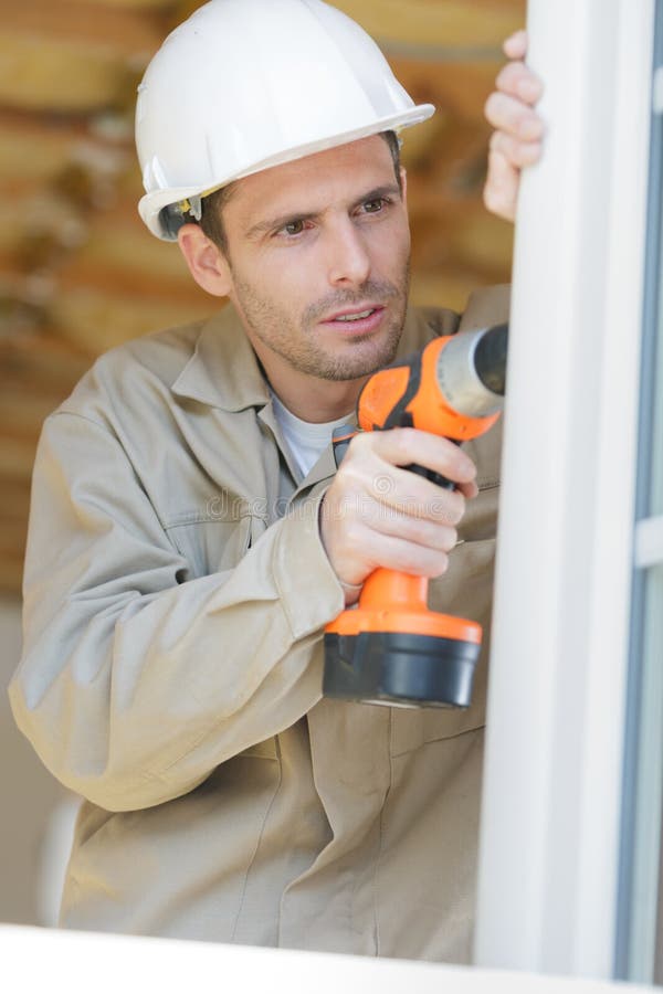 Builder Using Cordless Drill To Install Windows Stock Image - Image of ...