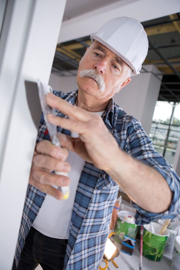 Builder Using Device on Wall Stock Photo - Image of rough, professional ...