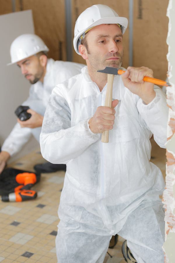 Builder Using Hammer To Remove Plaster from Wall Stock Image - Image of ...