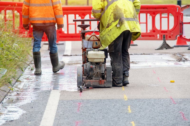Builder Using Petrol Powered Road Saw with Dimond Blade To Cut Asphalte ...