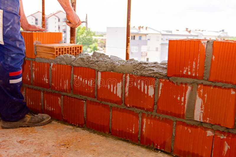Builder Using Spatula To Set Up Mortar Over Red Brick, Building Site ...