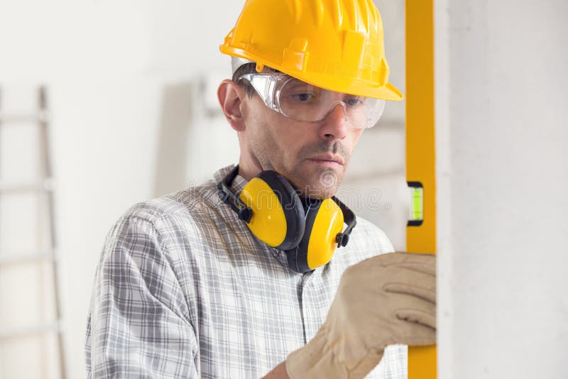 Builder Using a Spirit Level on a Vertical Wall Stock Photo - Image of ...
