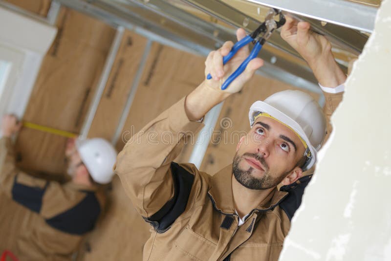 Builder Using Tool To Fix Ceiling Indoors Stock Image - Image of ...