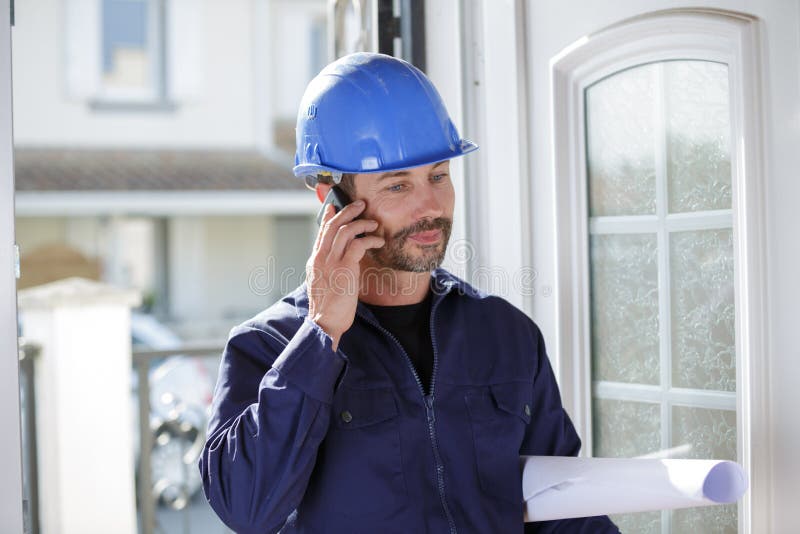 Builder Wearing Protective Helmet on Phone Stock Photo - Image of ...