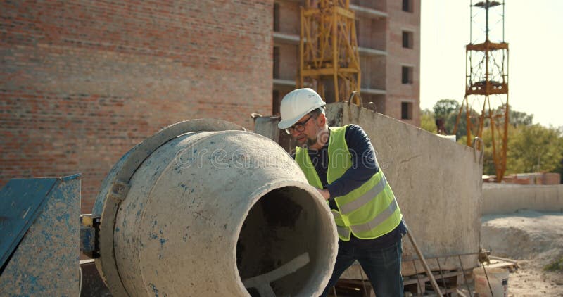 Builder Working with a Concrete Mixer on a Construction Stock Video ...