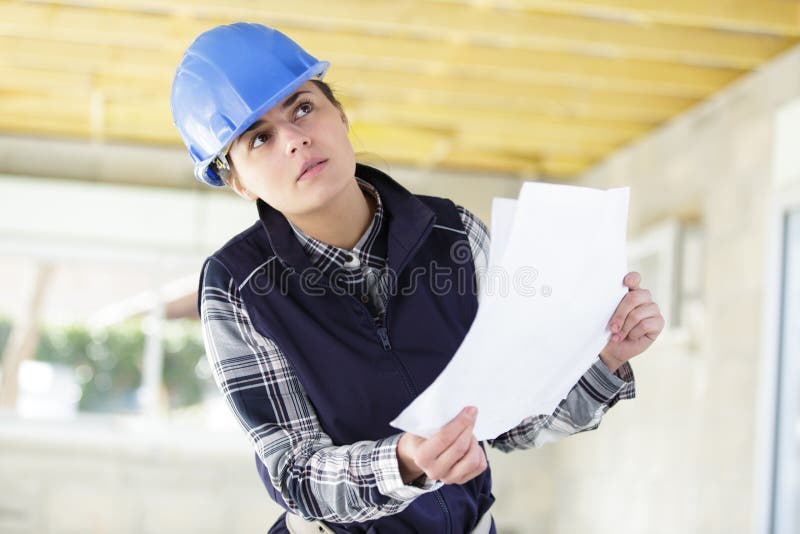 Builder Woman on Construction Site with Helmet and Drawing Paper Stock ...