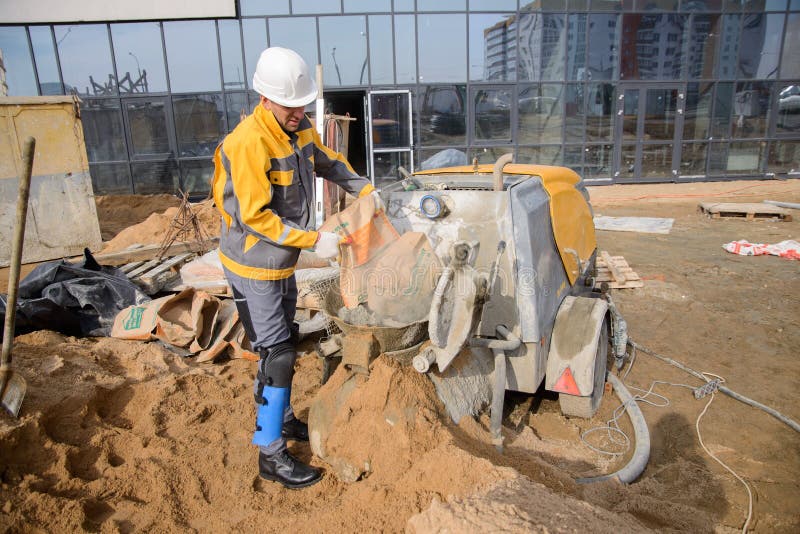 A Builder in Work Clothes is Doing His Job Stock Photo - Image of ...