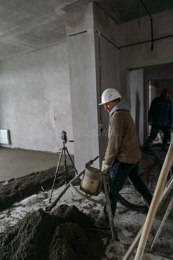 A Builder in Work Clothes is Doing His Job Stock Image - Image of ...