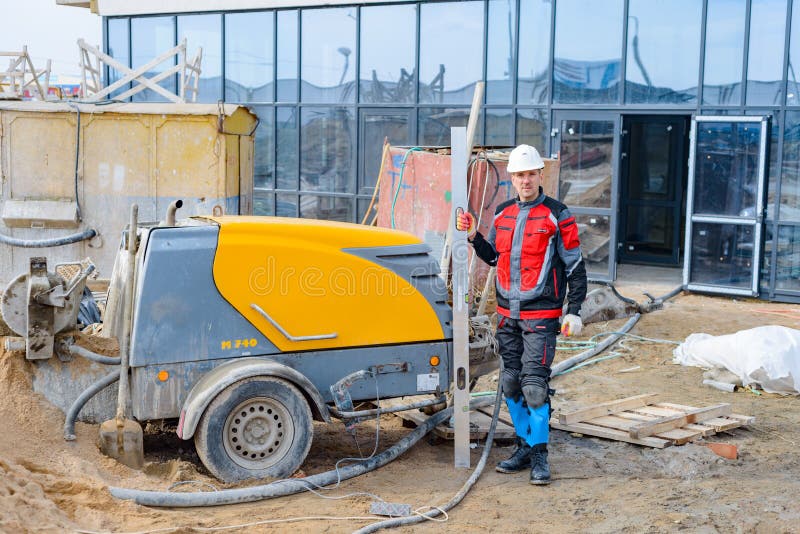 A Builder in Work Clothes is Doing His Job Stock Photo - Image of ...