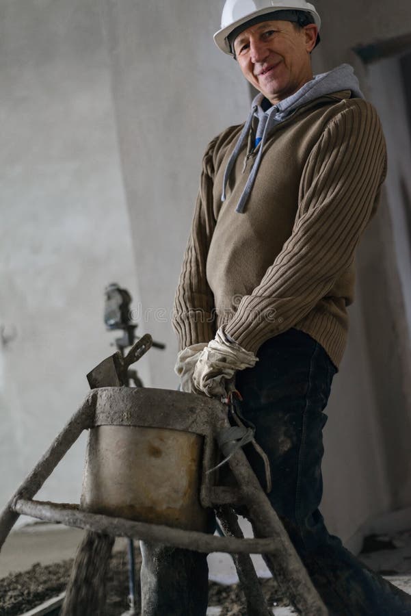 A Builder in Work Clothes is Doing His Job Stock Photo - Image of ...