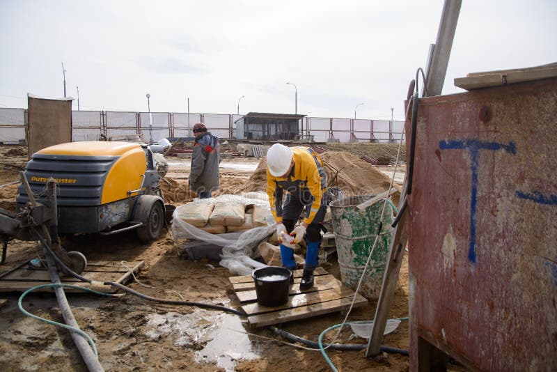 Builder in Work Clothes Prepares Tools and Materials Editorial Photo ...