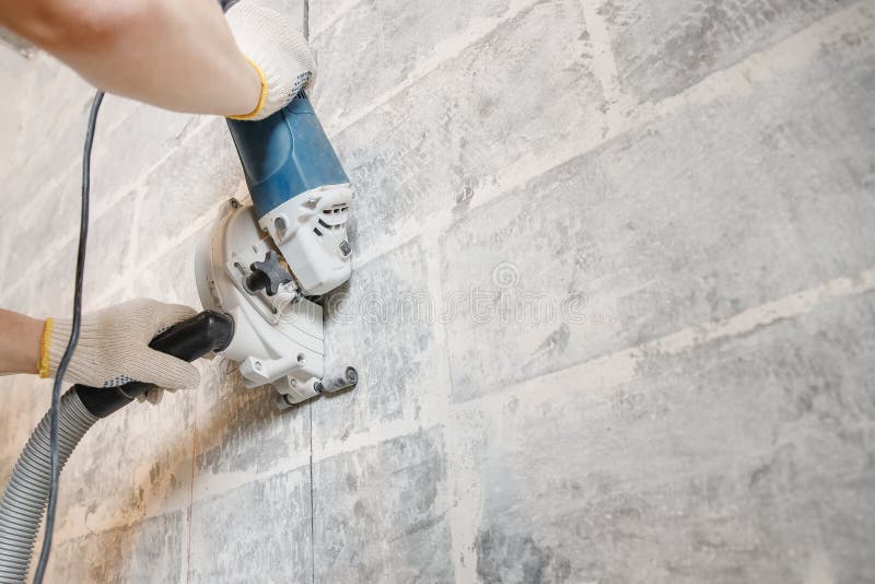 Builder Worker Cutting Electrical Chase in Concrete Wall with ...