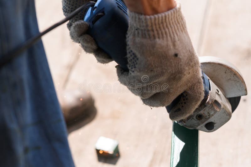 Builder Worker with Grinder Machine Cutting Metal Wood at Construction ...