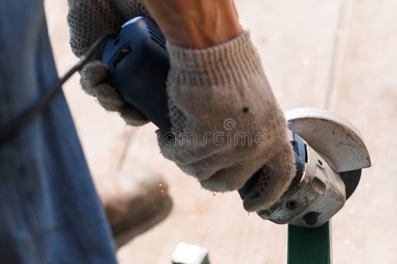 Builder Worker with Grinder Machine Cutting Metal Wood at Construction ...