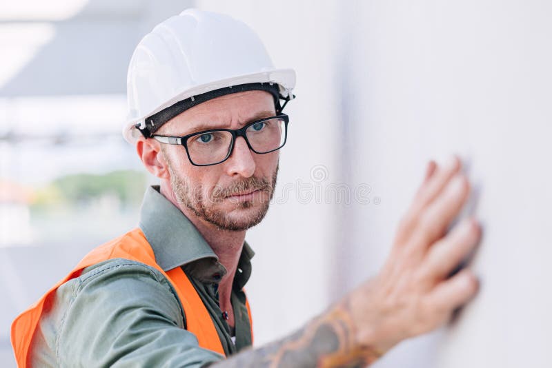 Builder Worker Look at Construction Plastering Wall for High Precision ...