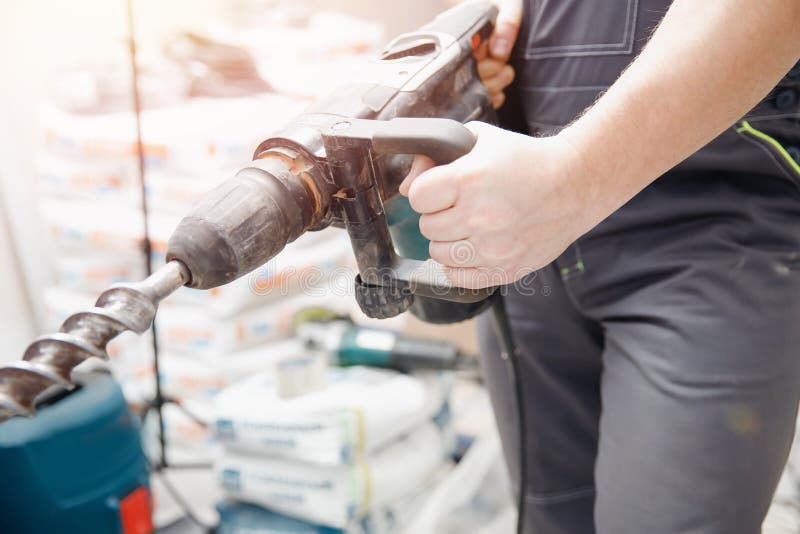 Builder Worker Man with Hammer Drill Perforator Equipment Making Hole ...