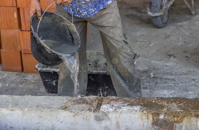 Builder Worker Wetting Concrete with Bucket of Water 2 Stock Image ...