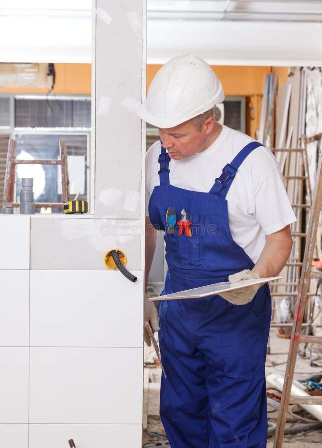 Builder Working with Ceramic Tiles Stock Photo - Image of interior ...