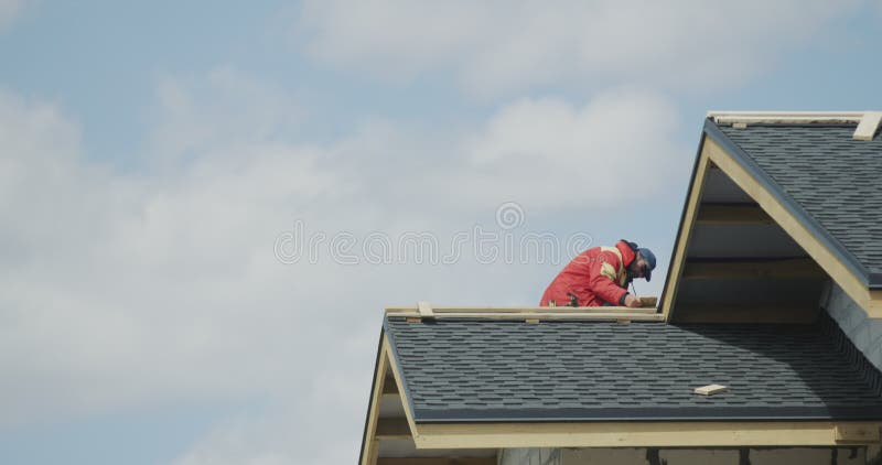 The Builder is Working on the Roof of the House - Laying Shingles Stock ...