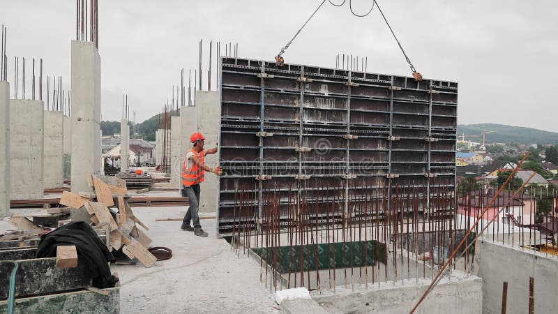 The Builder Works on the Construction Site. Installation of a Large ...