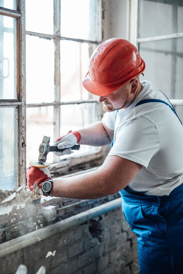Construction Worker Working with a Hammer, Destroying Old Brick Walls ...