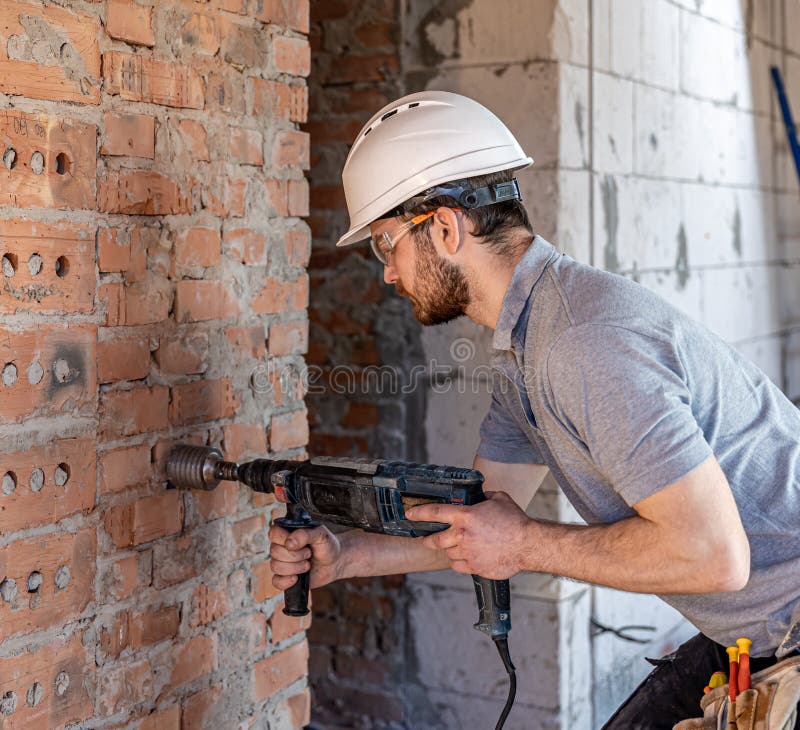 The Builder Works with a Drill in Working Form Stock Photo - Image of ...