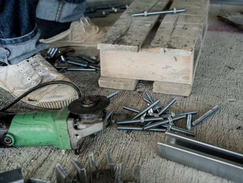 A Builder Works with Screws and Nuts on a Wooden Pallet Stock Image ...