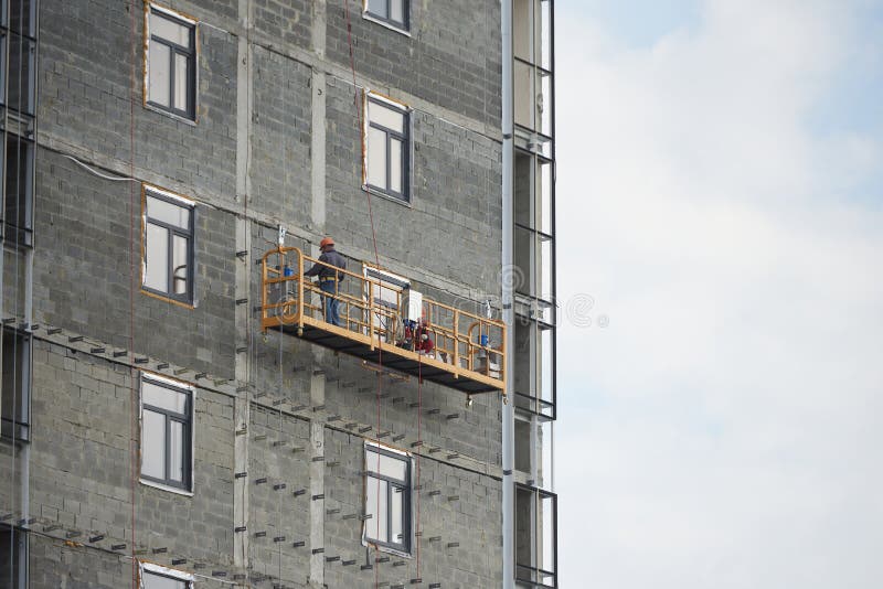 Builder Works in a Special Suspended Platform at the Construction of an ...