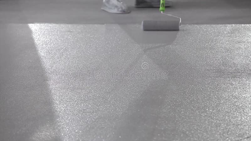 The Builder Works with a Spiked Roller. Creation of Self-leveling ...