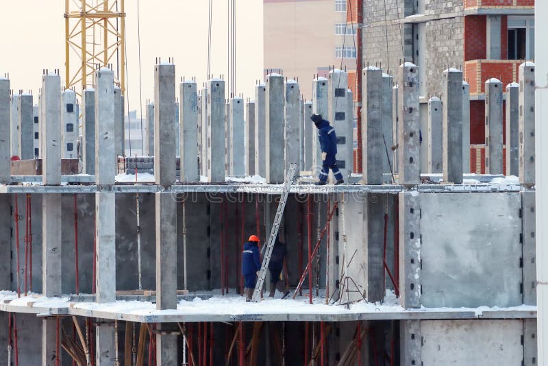 Builders in Blue Clothes on Construction of Building Stock Image ...
