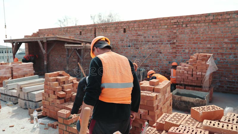 Builders Building a Brick Wall. Construction Work on Construction Stock ...
