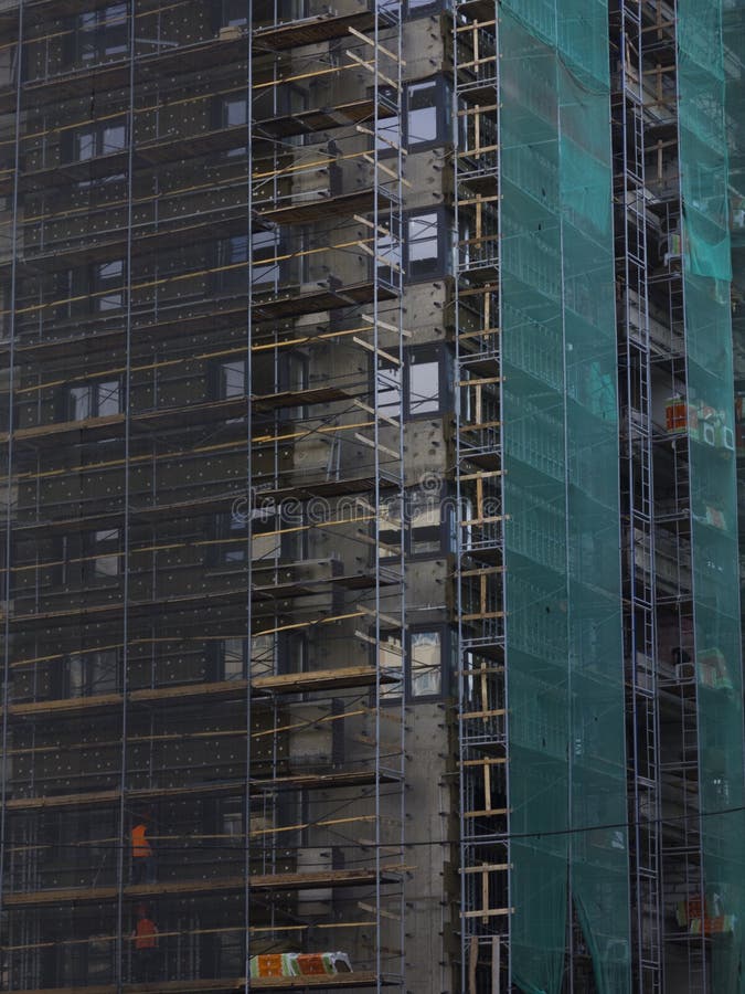 Builders are Building a Multi-storey House. Scaffolding and Materials ...