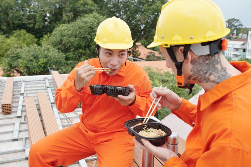 Builders Eating Lunch at Construction Site Stock Image - Image of ...