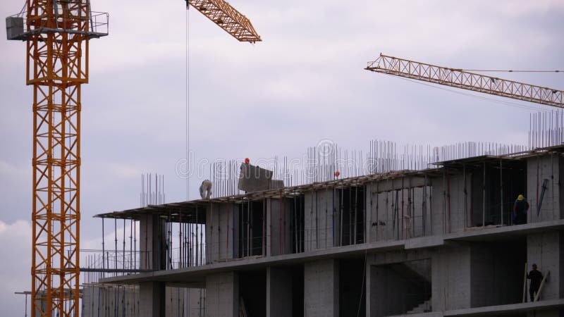 Builders on the Edge of a Skyscraper Under Construction. Workers at a ...